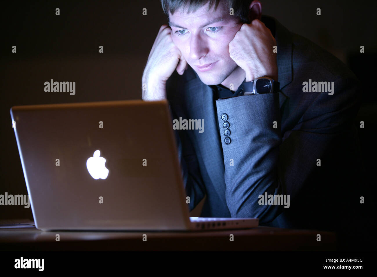 Male person working with a laptop computer Stock Photo - Alamy