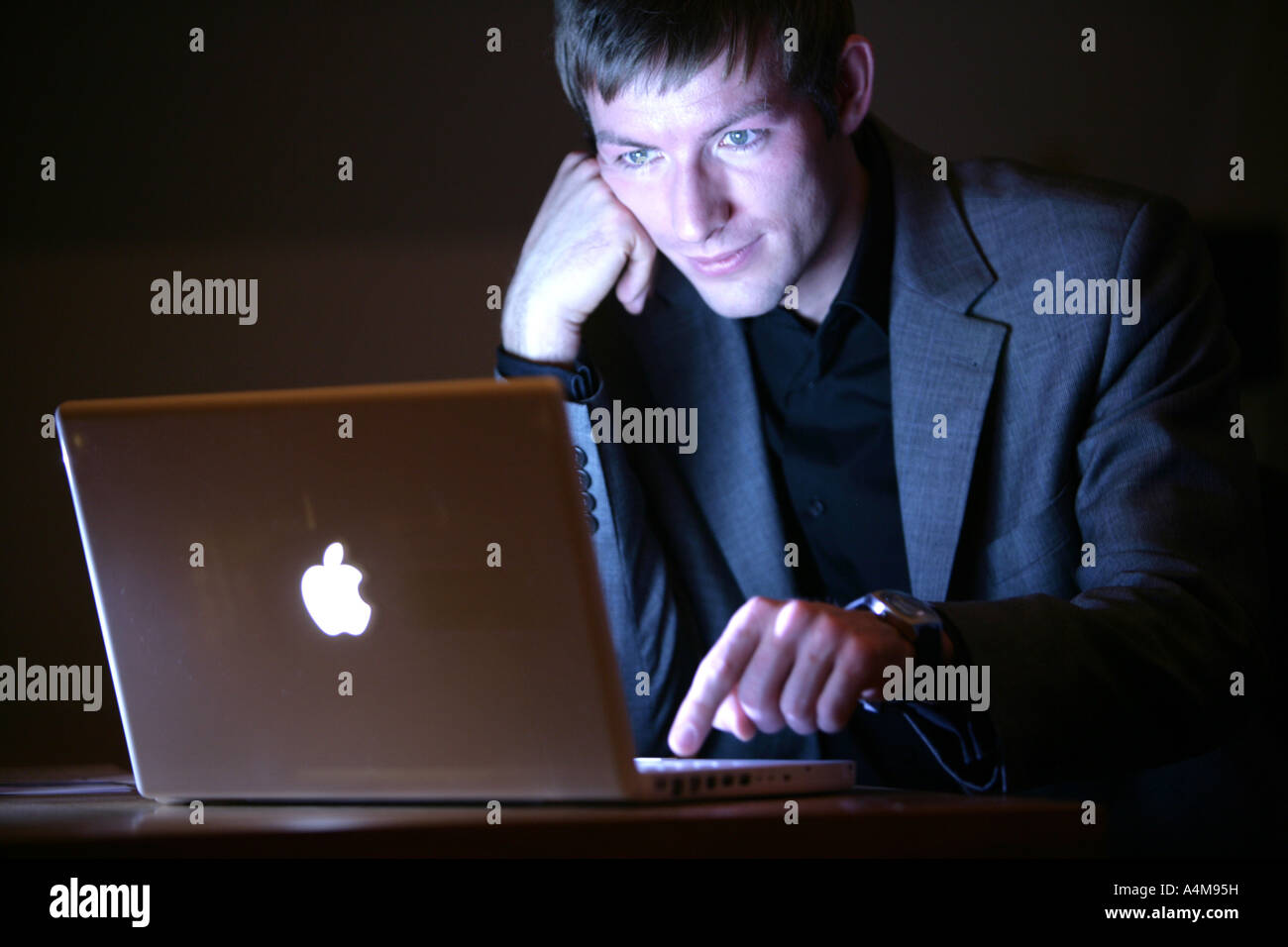 Male person working with a laptop computer Stock Photo - Alamy