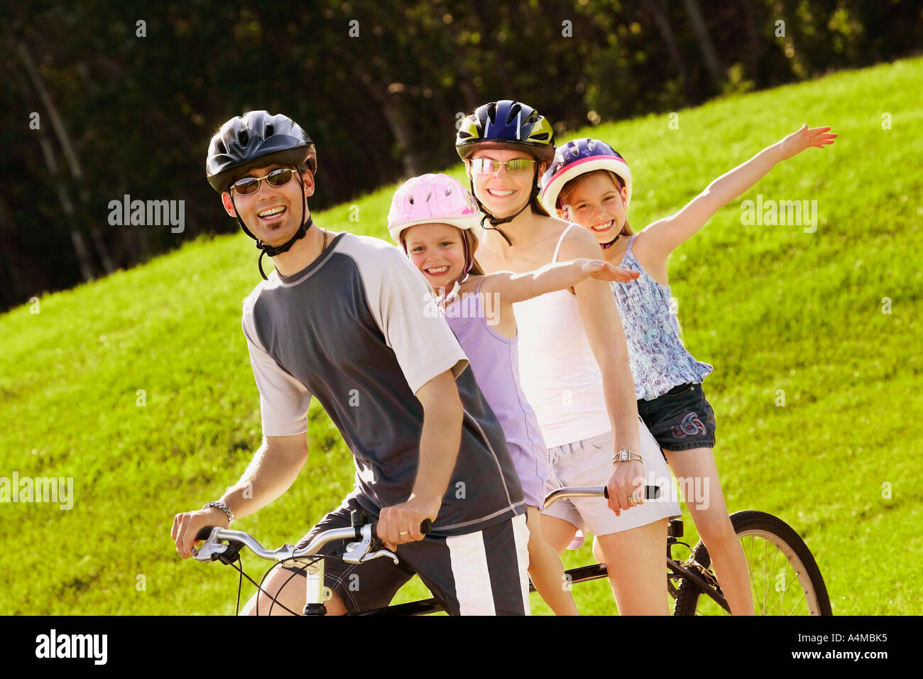 Family riding a tandem bicycle hi-res stock photography and images - Alamy