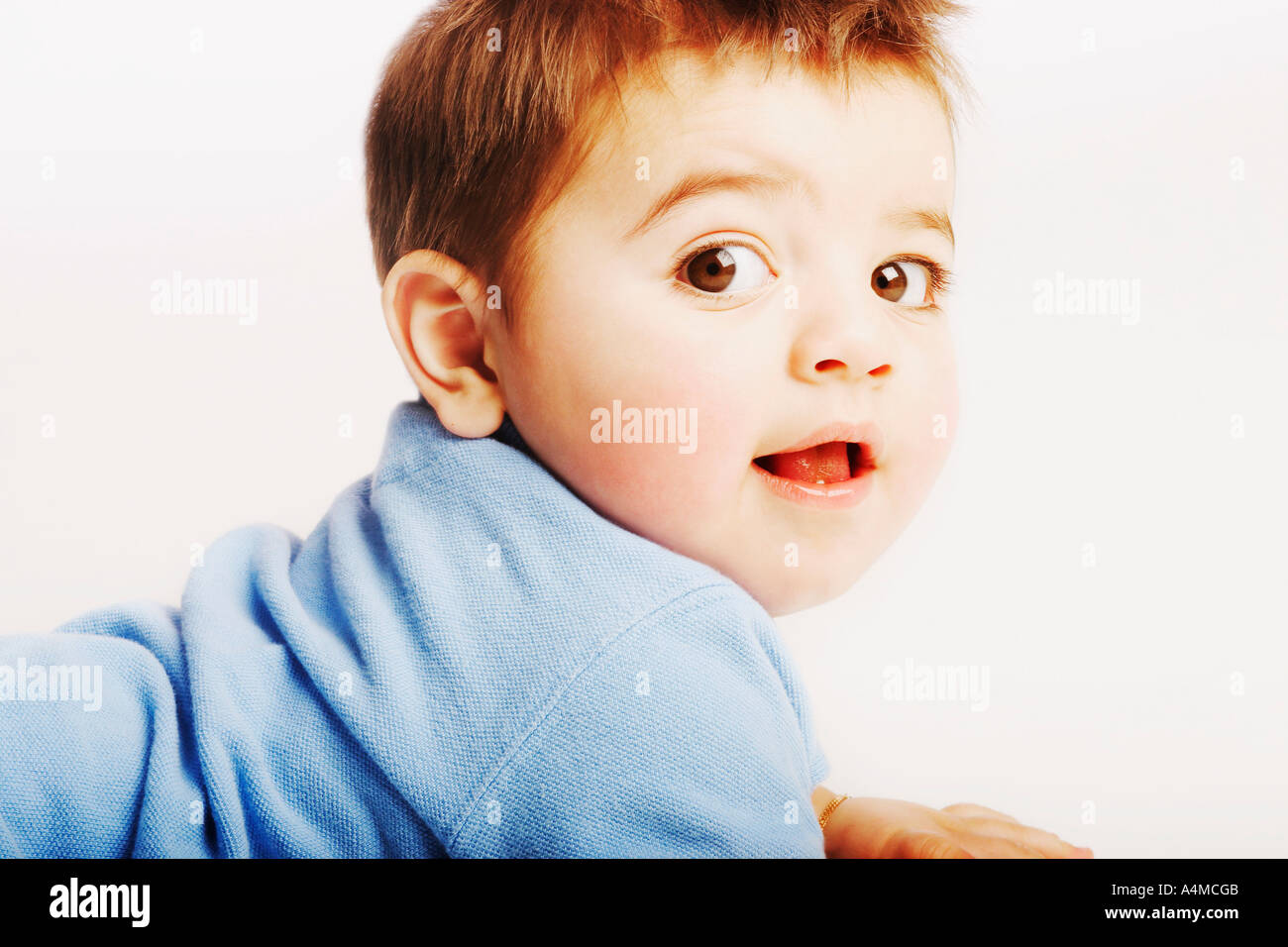 A baby looks over shoulder Stock Photo - Alamy
