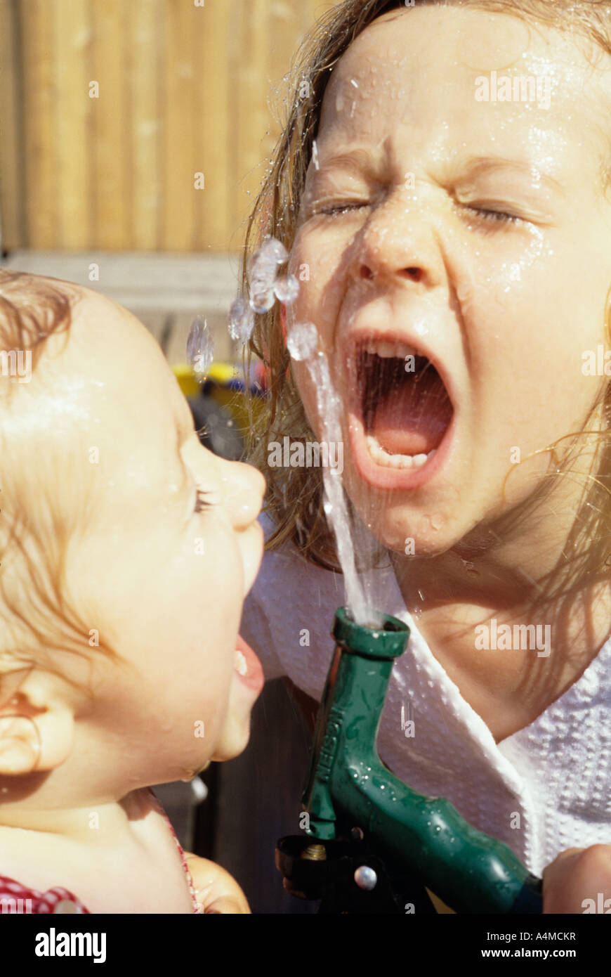Two children drink water from hi-res stock photography and images - Alamy