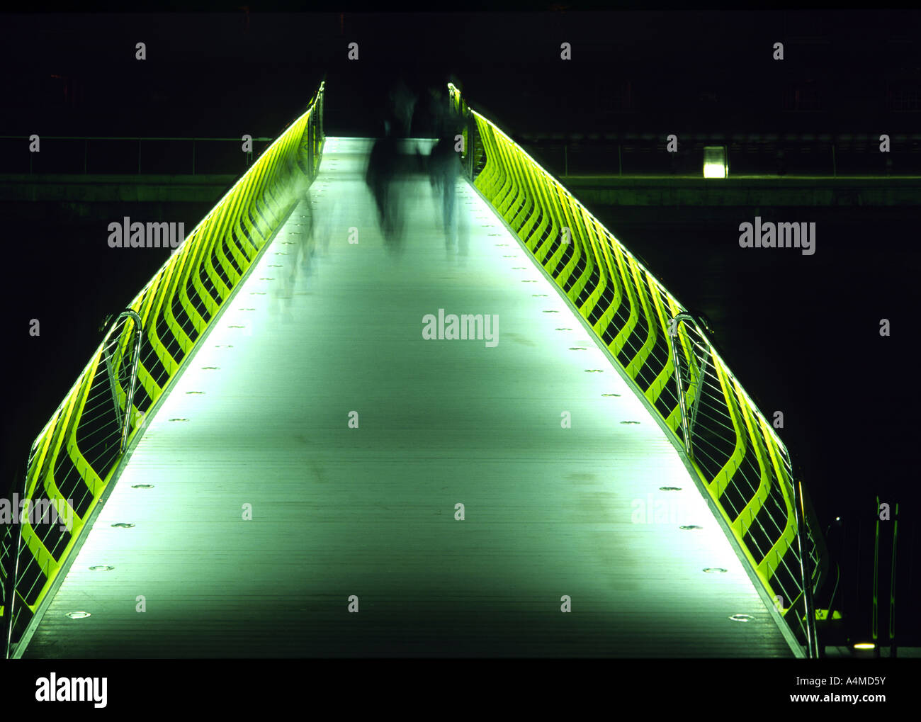 People crossing footbridge at night at Canary Wharf, London Stock Photo ...