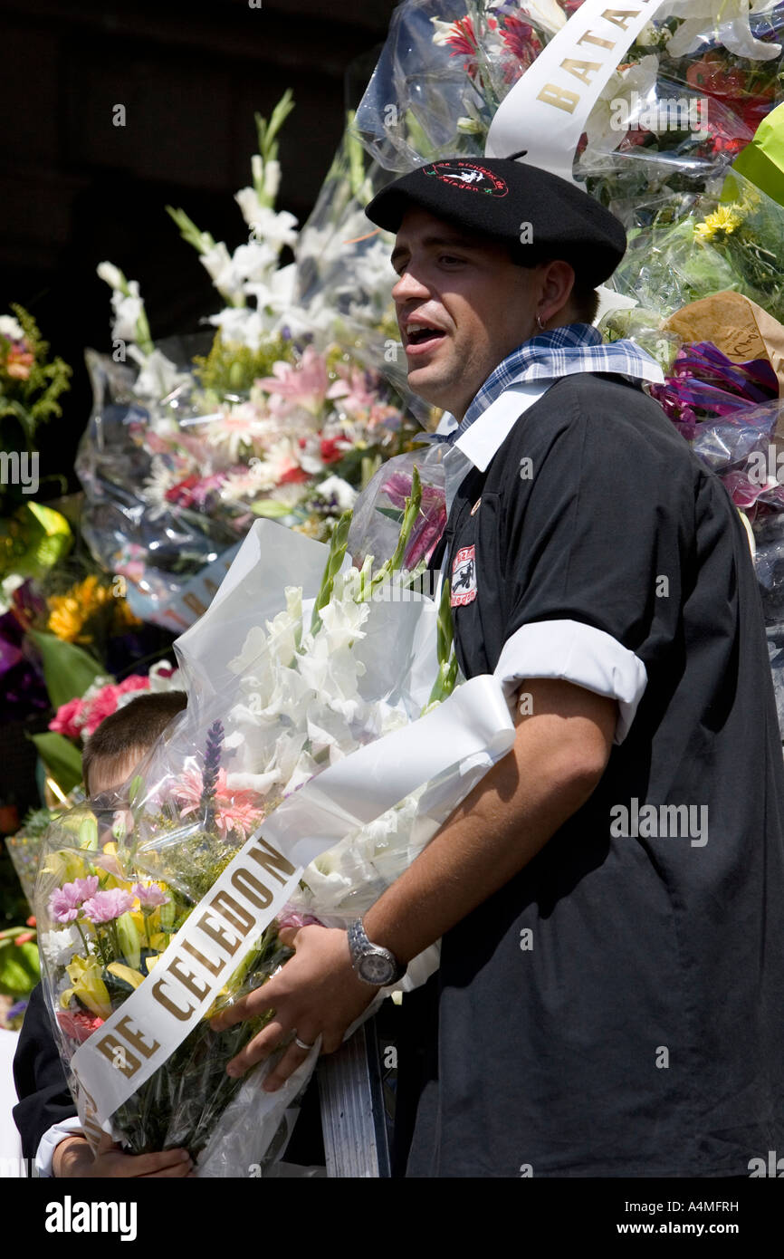 Basque man in traditional dress with floral tribute outside church of ...