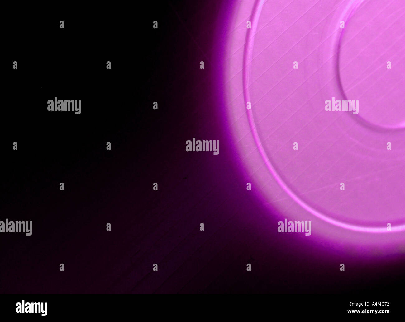 Pink disc on a black background Stock Photo - Alamy