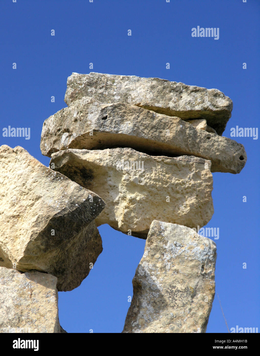 Pile of rocks in an arch shape against a blue sky Stock Photo - Alamy