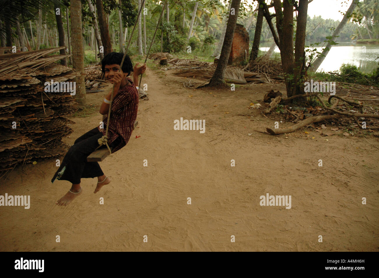 Girl on swing in Kerala India Stock Photo - Alamy