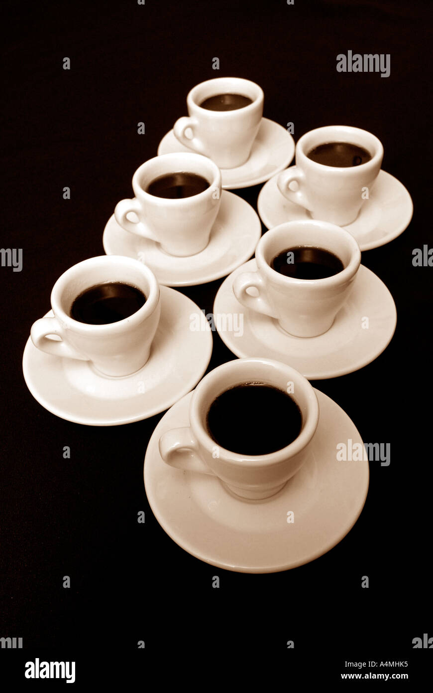Six cups of black coffee on black background Stock Photo - Alamy