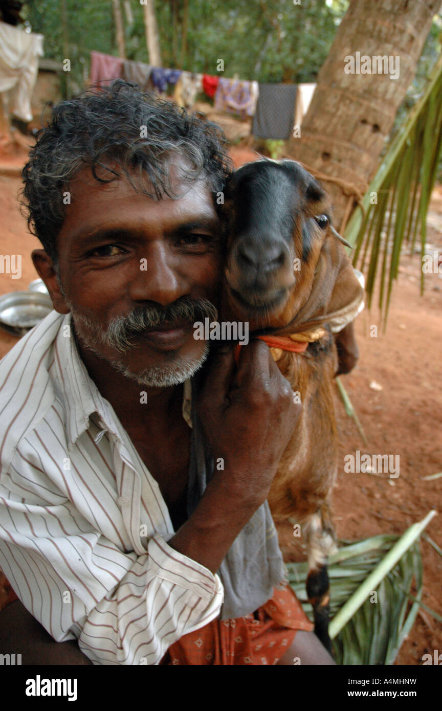 Goat and owner in Kerala India Stock Photo - Alamy