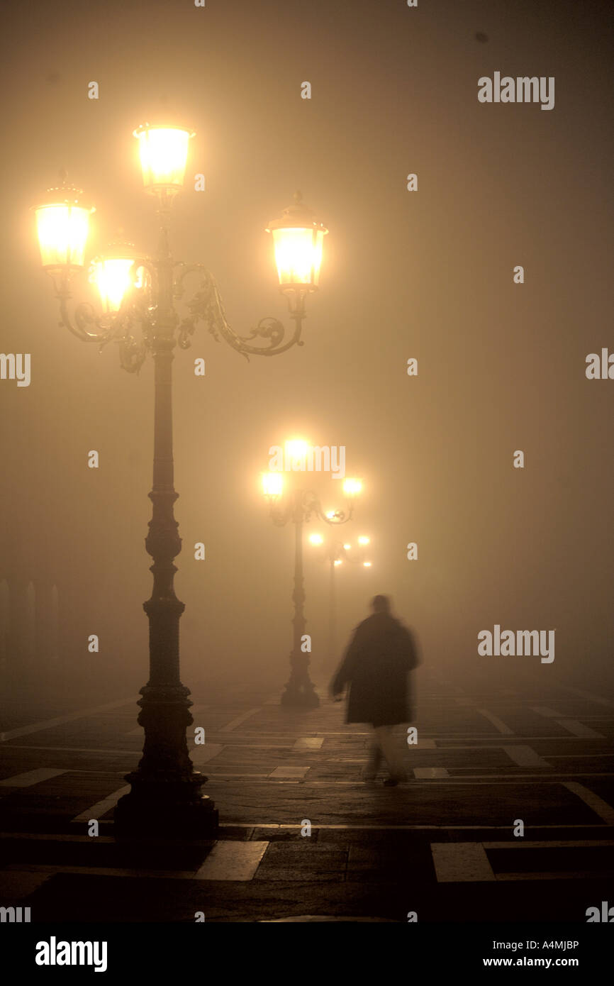 Person walking through mist at night. St Mark's Square, San Marco ...