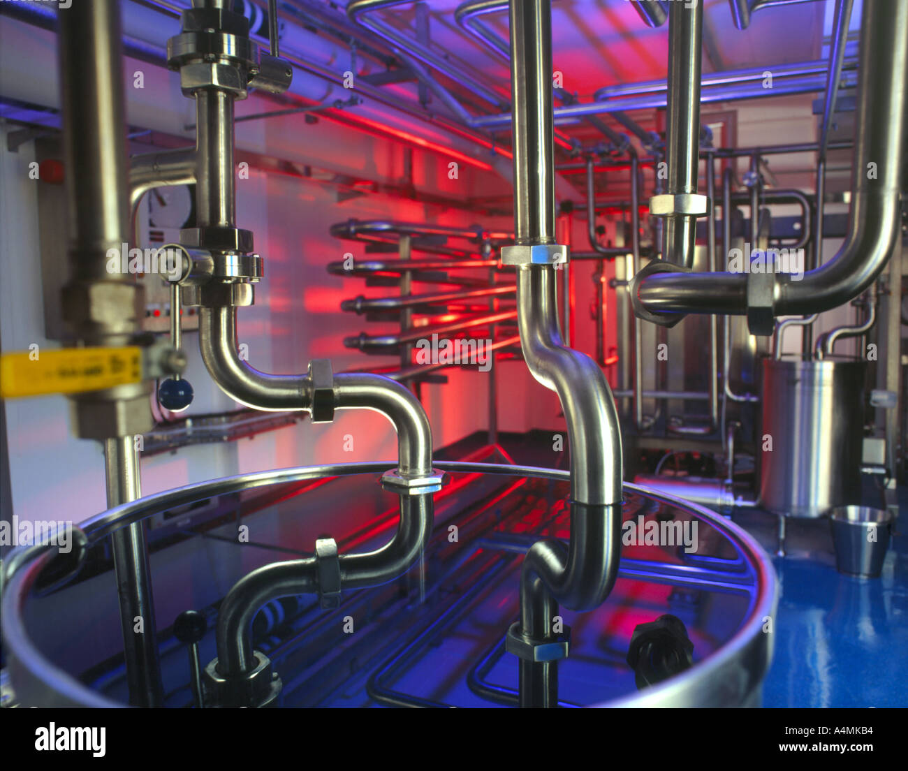 Part of the milk cooling pipes in a modern dairy. Red and blue gels ...