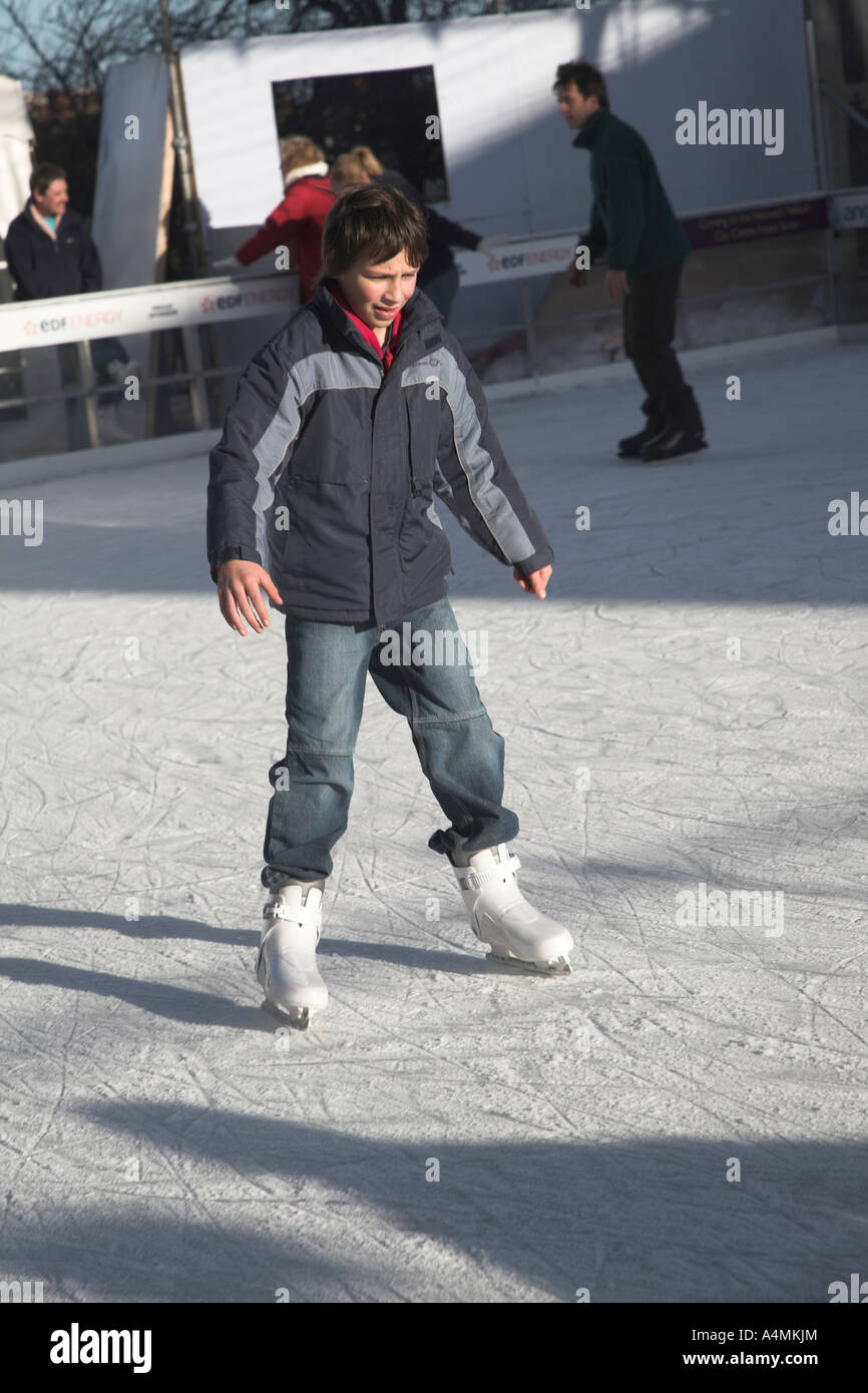 Boy ice skating at a temporary outdoors rink Norwich, Norfolk, England ...
