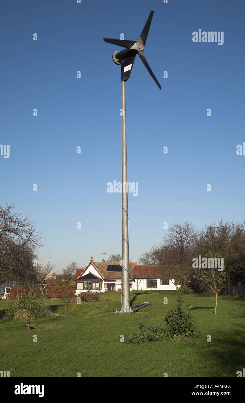 Single domestic wind turbine in a garden with bungalow house behind ...