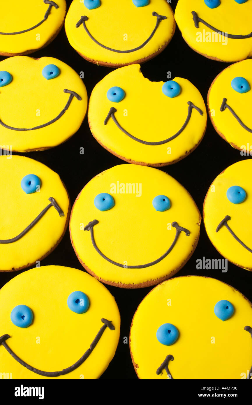 Smilely face cookies with one with a bite taken out Stock Photo - Alamy