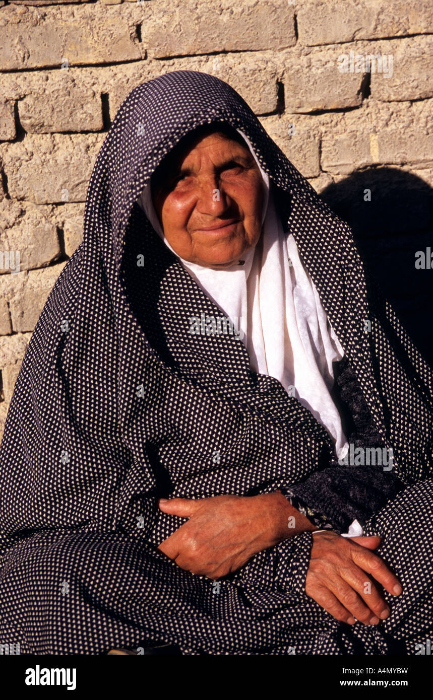 Iranian woman, dressing the traditional chador, with her son, Iran ...