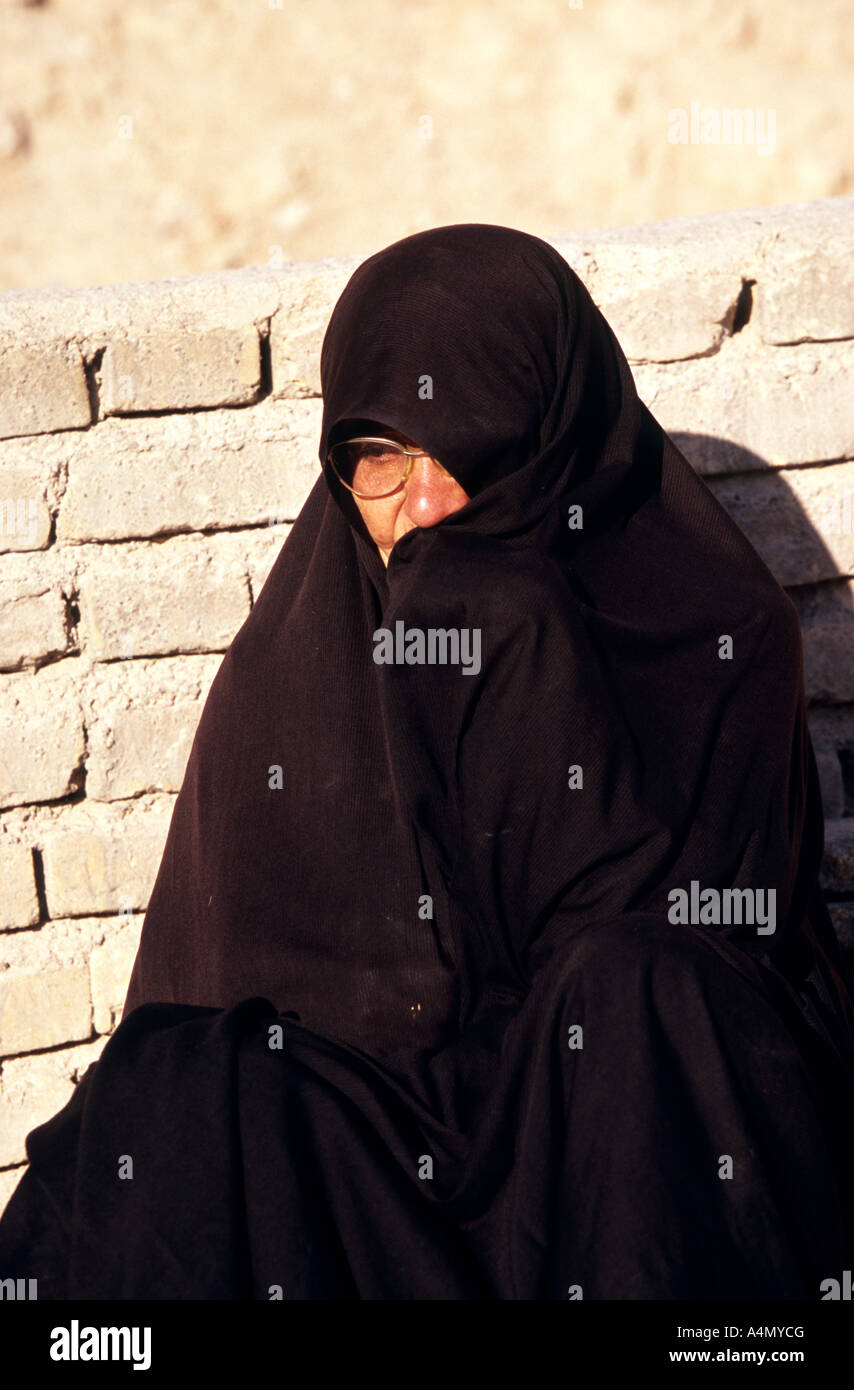 Iranian woman, dressing the traditional chador, with her son, Iran ...