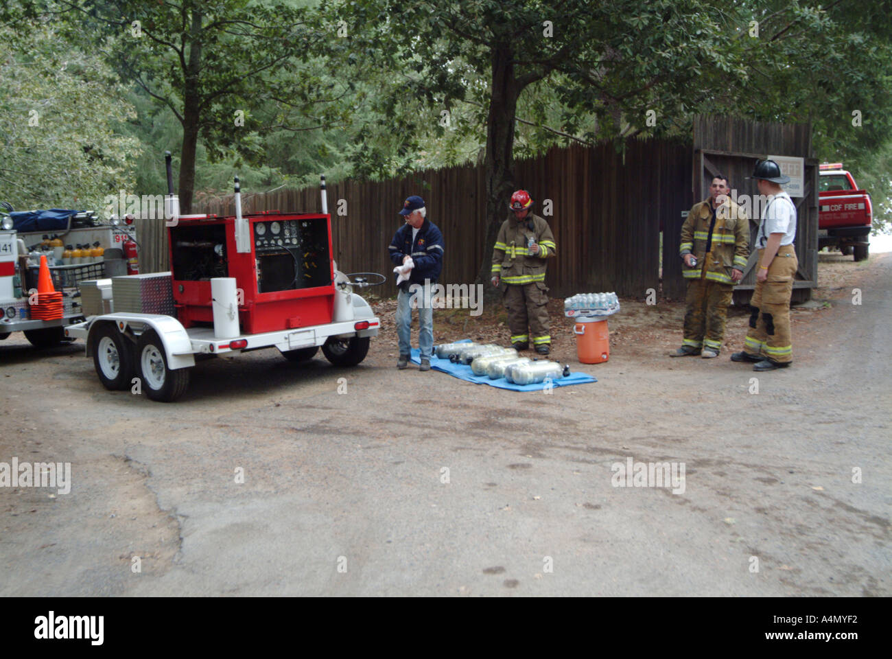 Fire fighters from several agencies clean up after a structure fire on ...