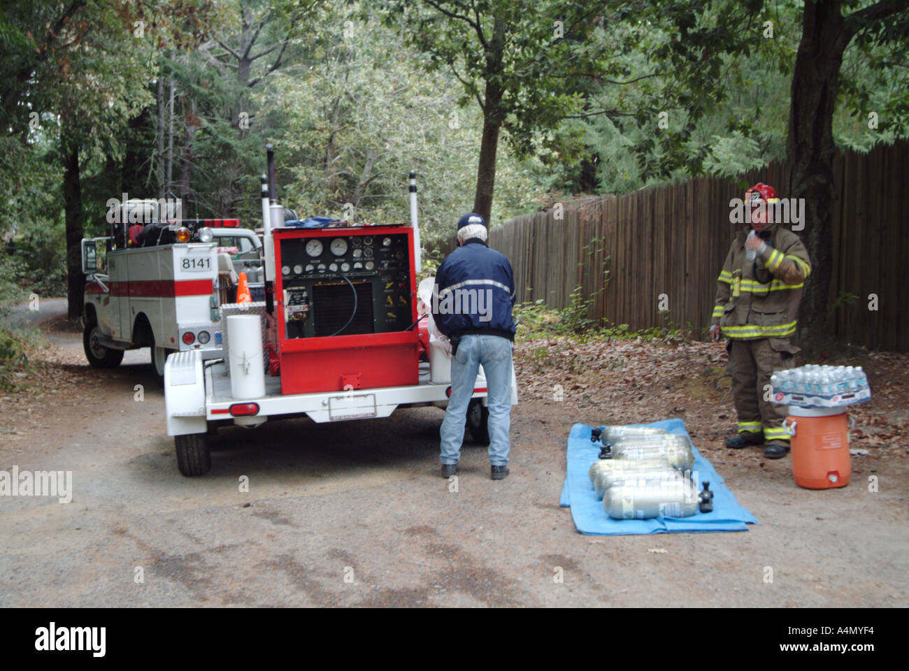Fire fighters from several agencies clean up after a structure fire on ...
