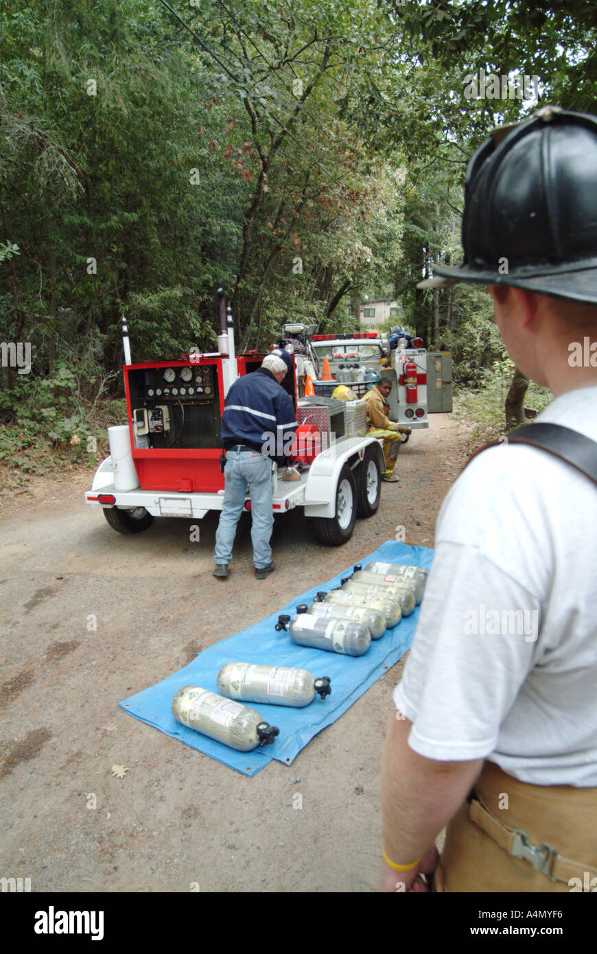 Fire fighters from several agencies clean up after a structure fire on ...