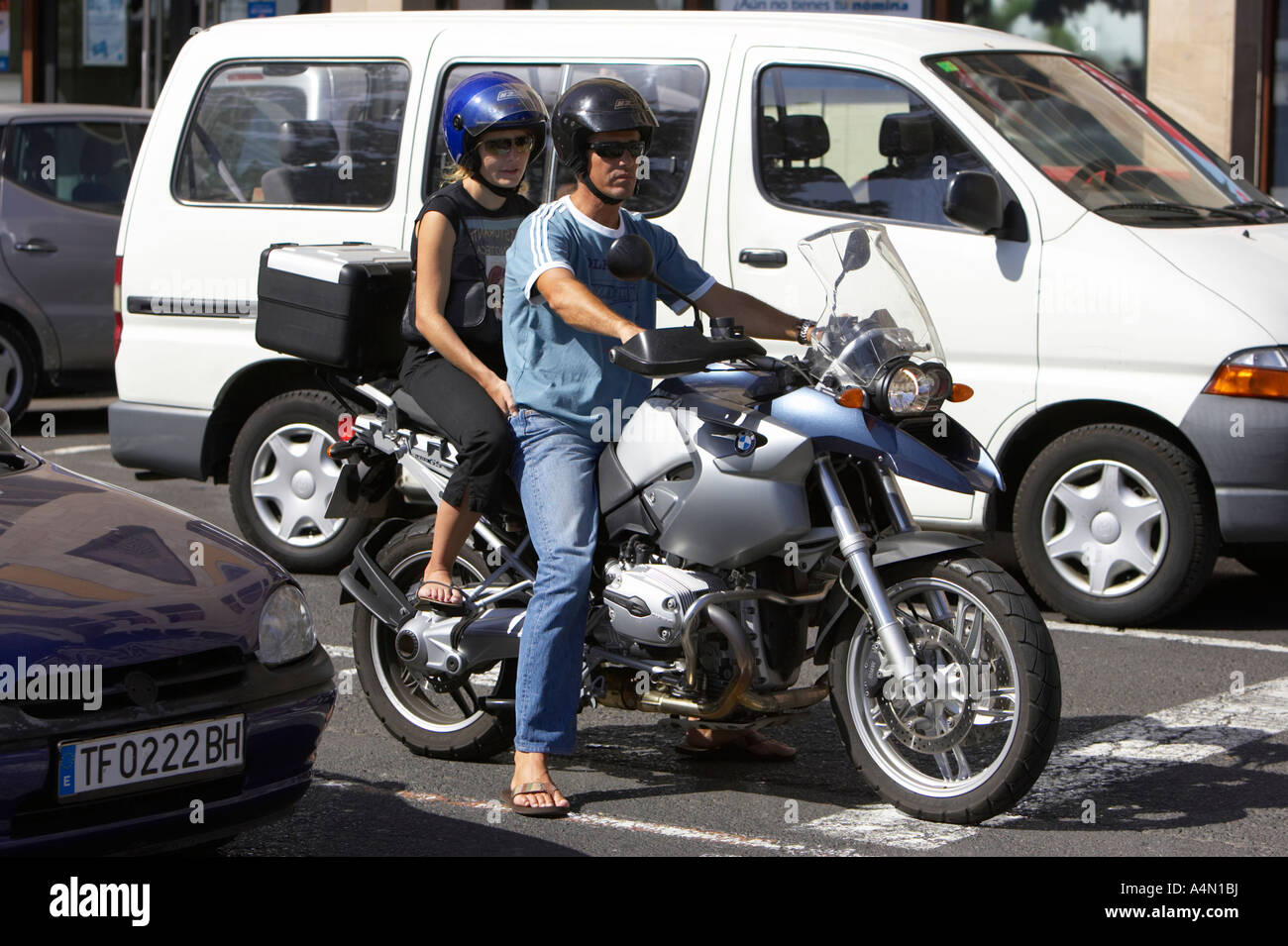 hispanic man on silver BMW GS R1200 motorcycle with female pillion ...