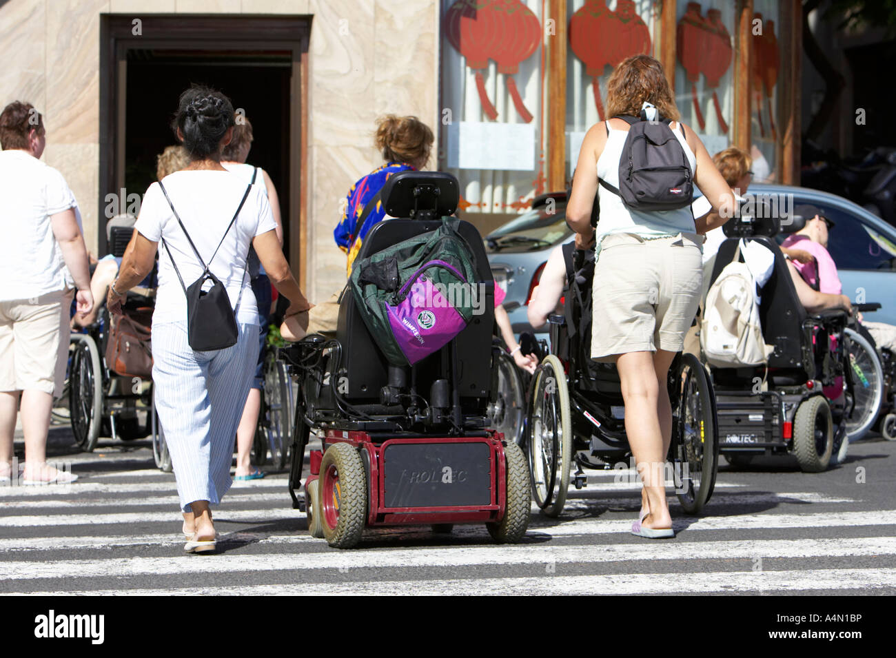 number of friends and helpers pushing and assisting people in ...