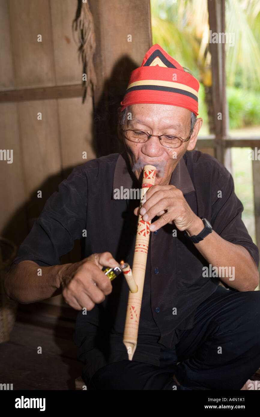 Malaysia Borneo Sarawak Cultural Village Bidayuh man lighting a pipe ...