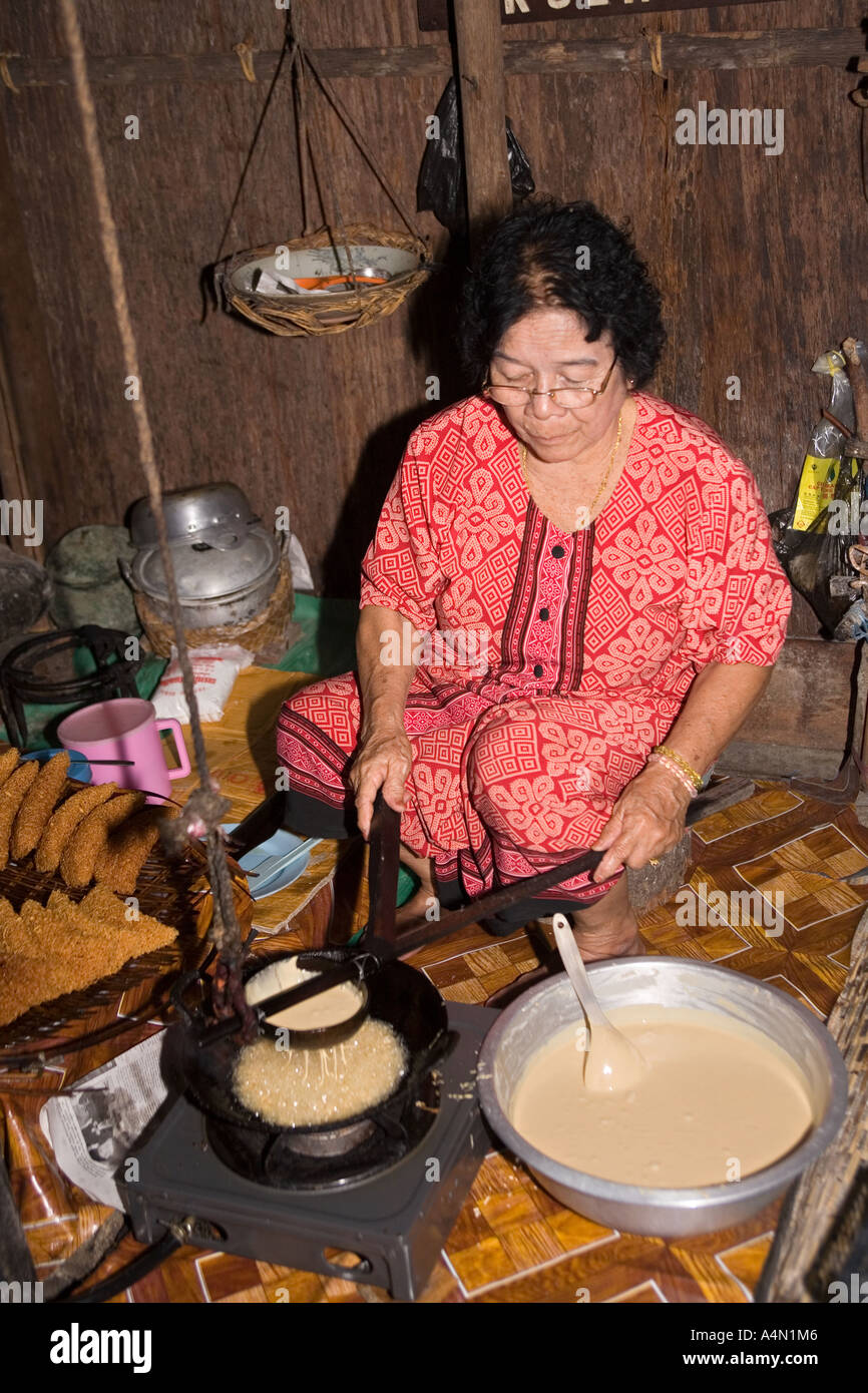 Malaysia Borneo Sarawak Cultural Village Iban woman frying sweet snack ...