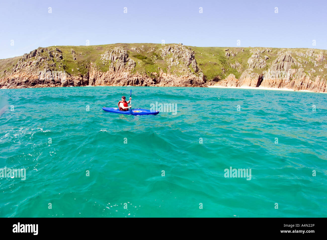 Man and kayak off Cornish coast near Porthcurno Stock Photo - Alamy