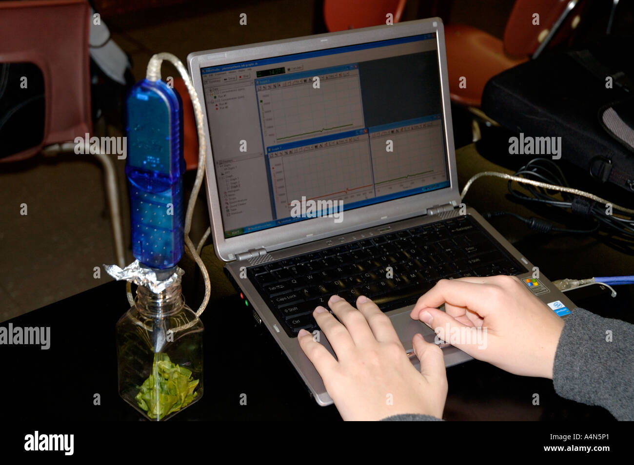 Student types keys data entry into laptop interfaced with carbon ...