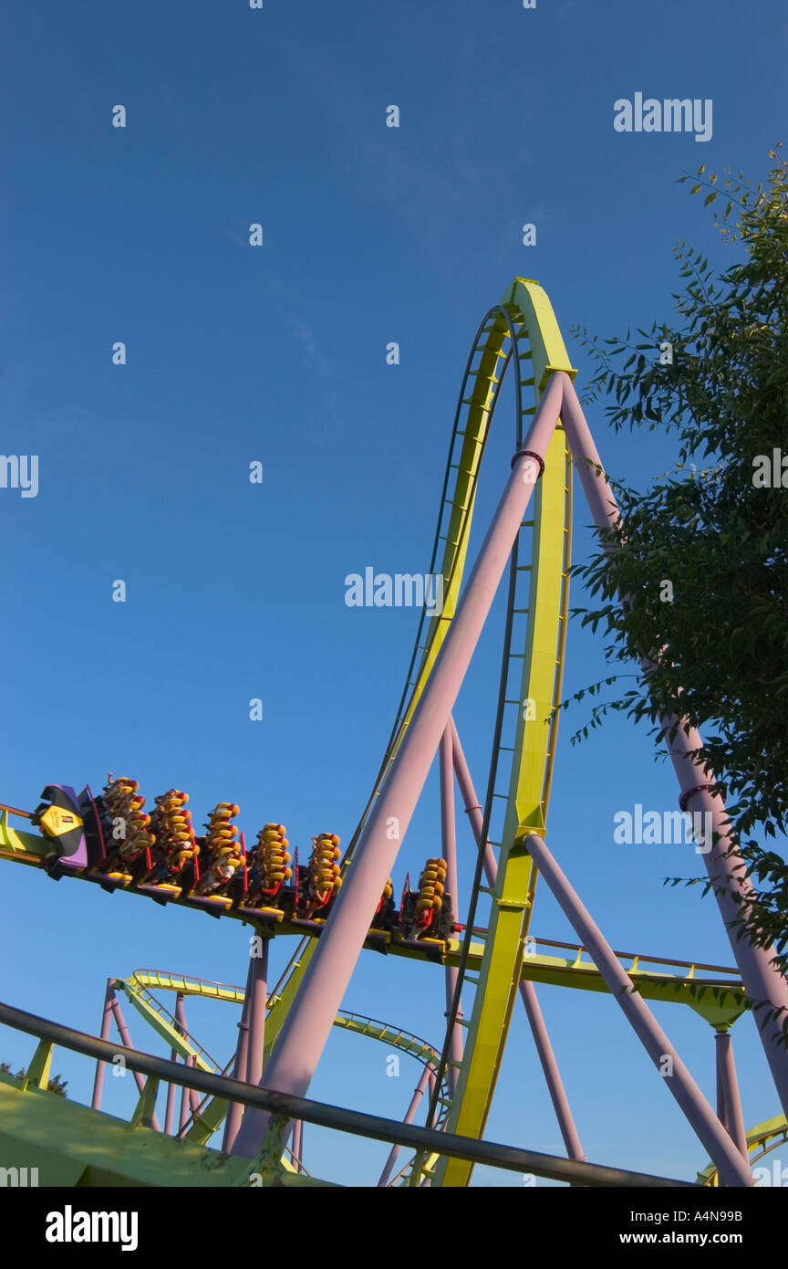 Amusement park roller coaster with riders Stock Photo - Alamy