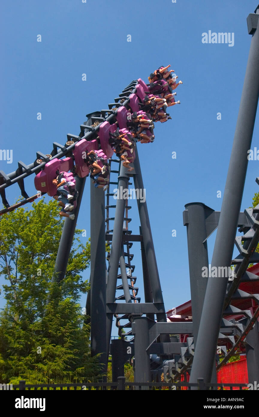 Amusement park roller coaster with riders Stock Photo - Alamy