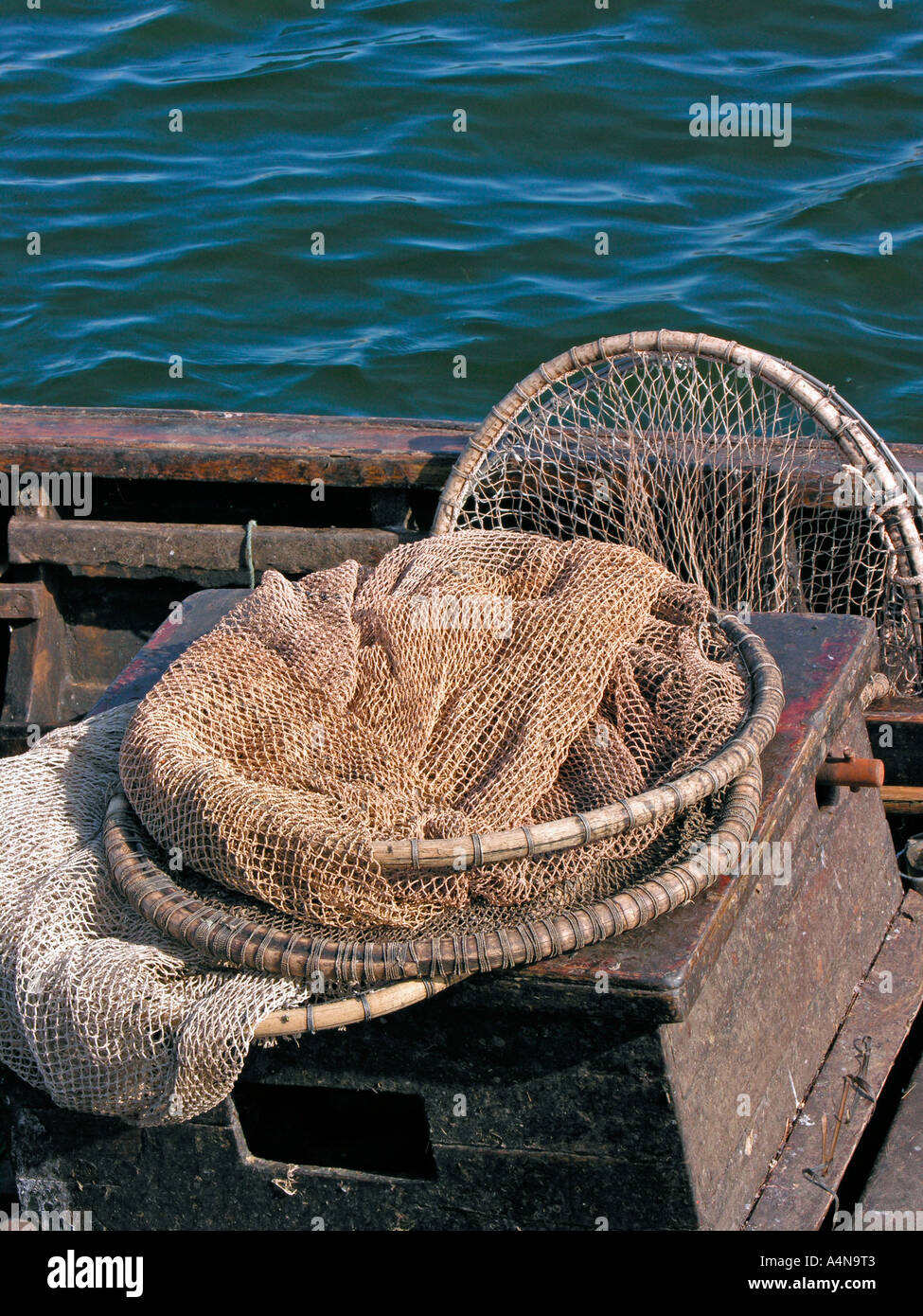 old wooden fishing boat with old nets and weirs Stock Photo - Alamy