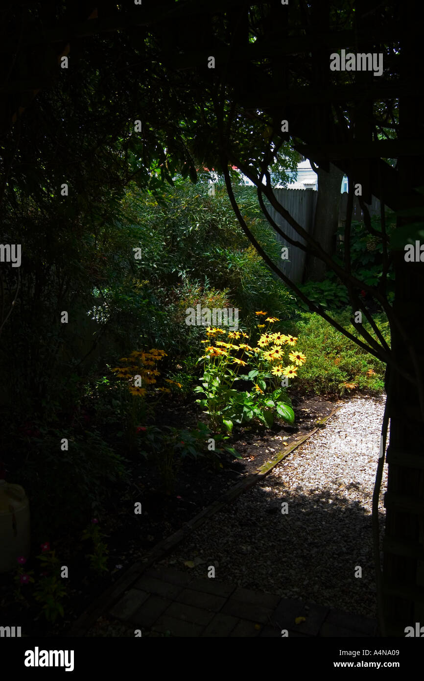 Garden pathway leading to secluded portion of fenced garden Stock Photo ...