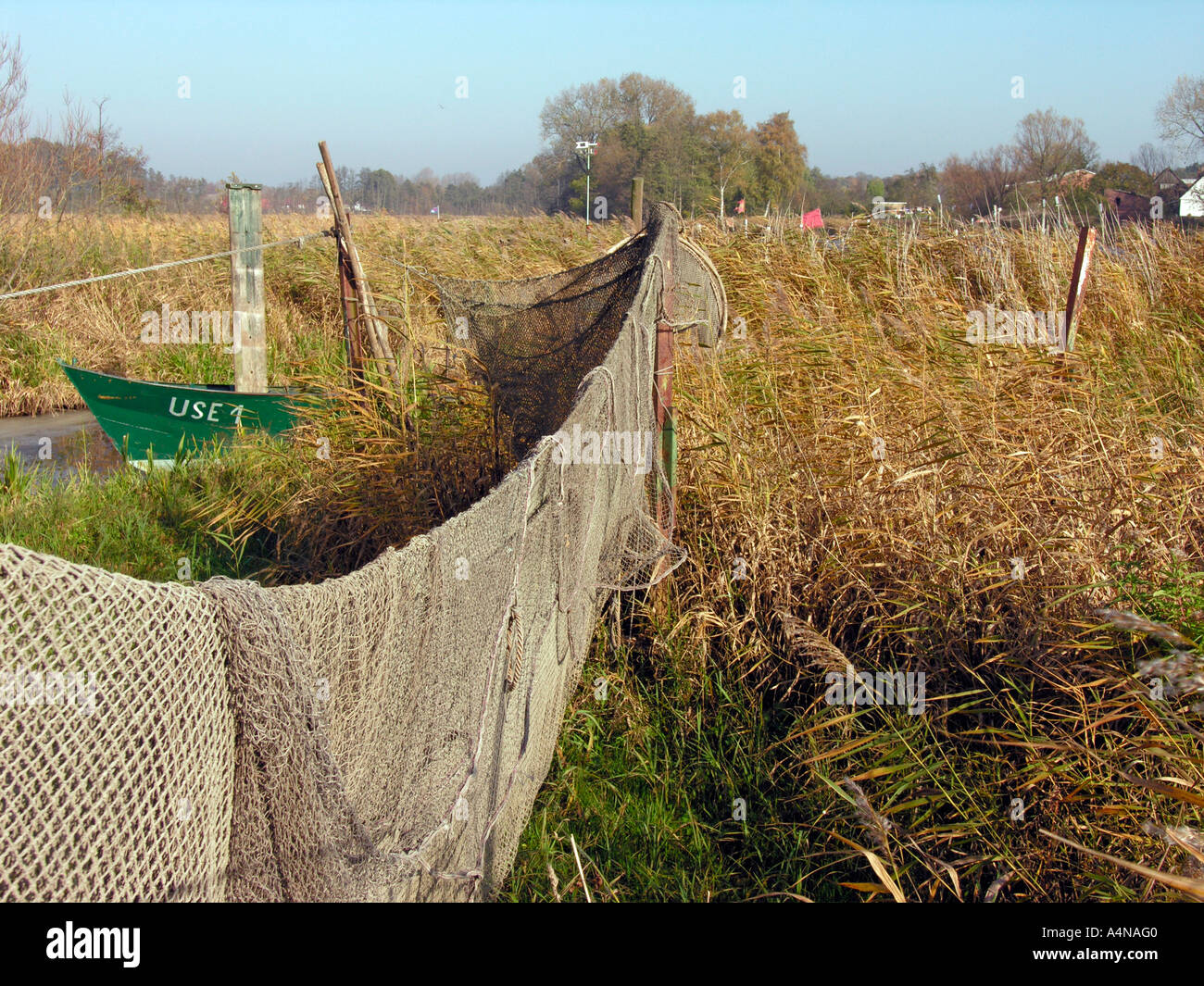 old fishing net hunging on a fence fishing boat at a little fisher port ...
