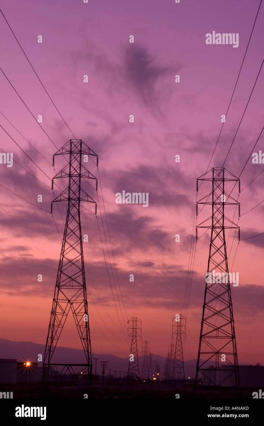 Rows Of Electrical Power Lines At Sunrise Sunset Golden Sky Stock Photo ...