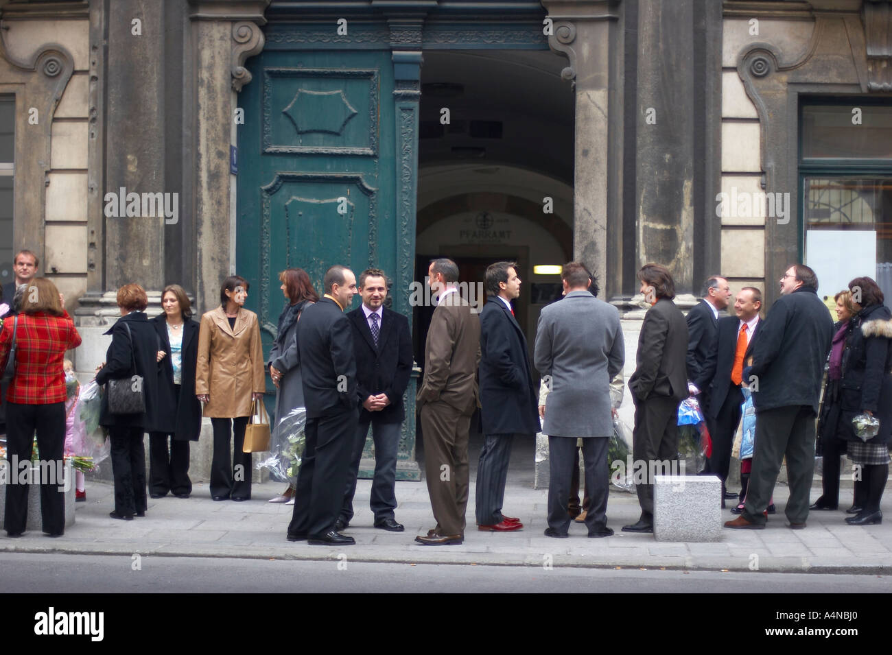 group of people waiting in front of a door Stock Photo - Alamy