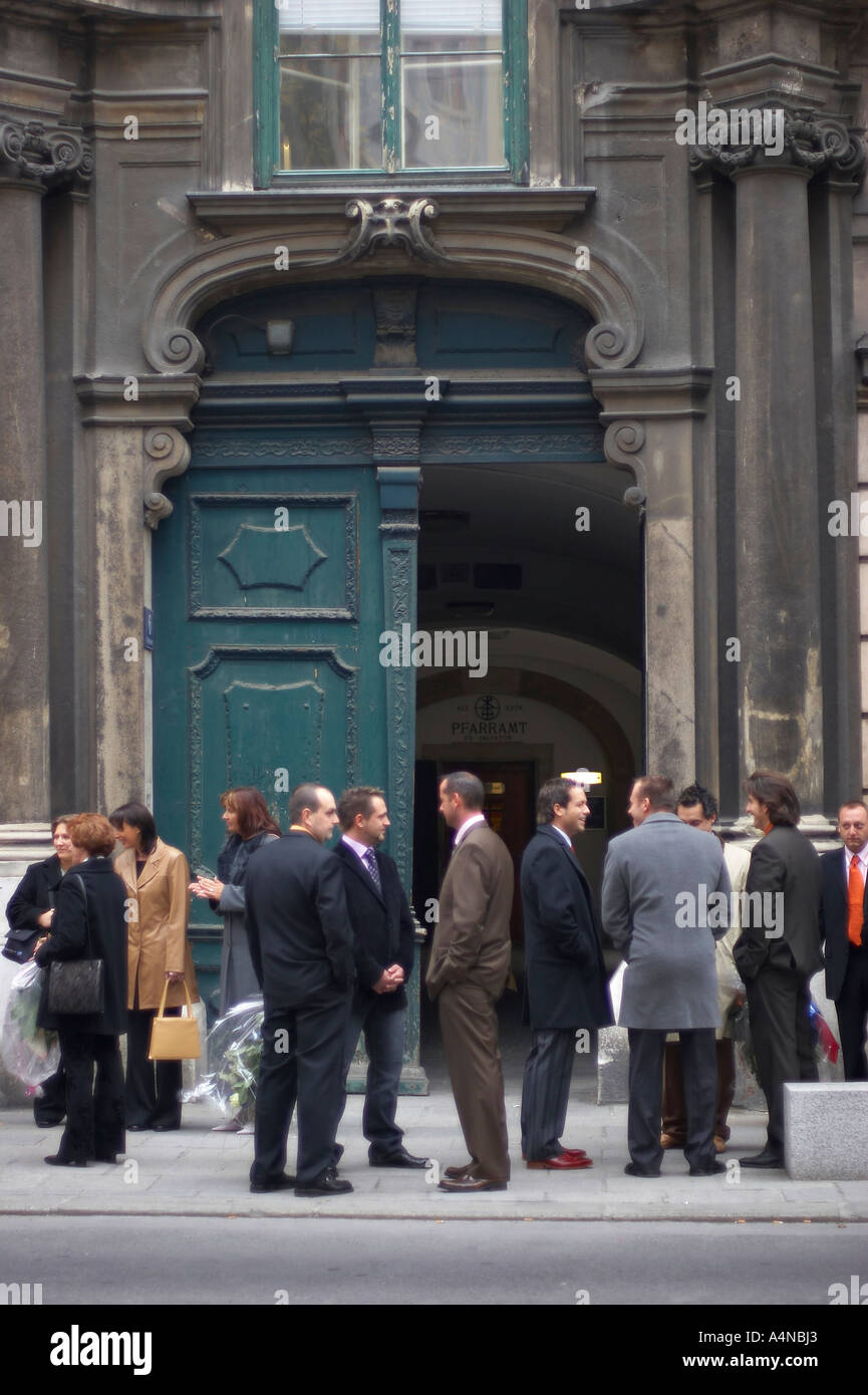 group of people waiting in front of a door Stock Photo - Alamy