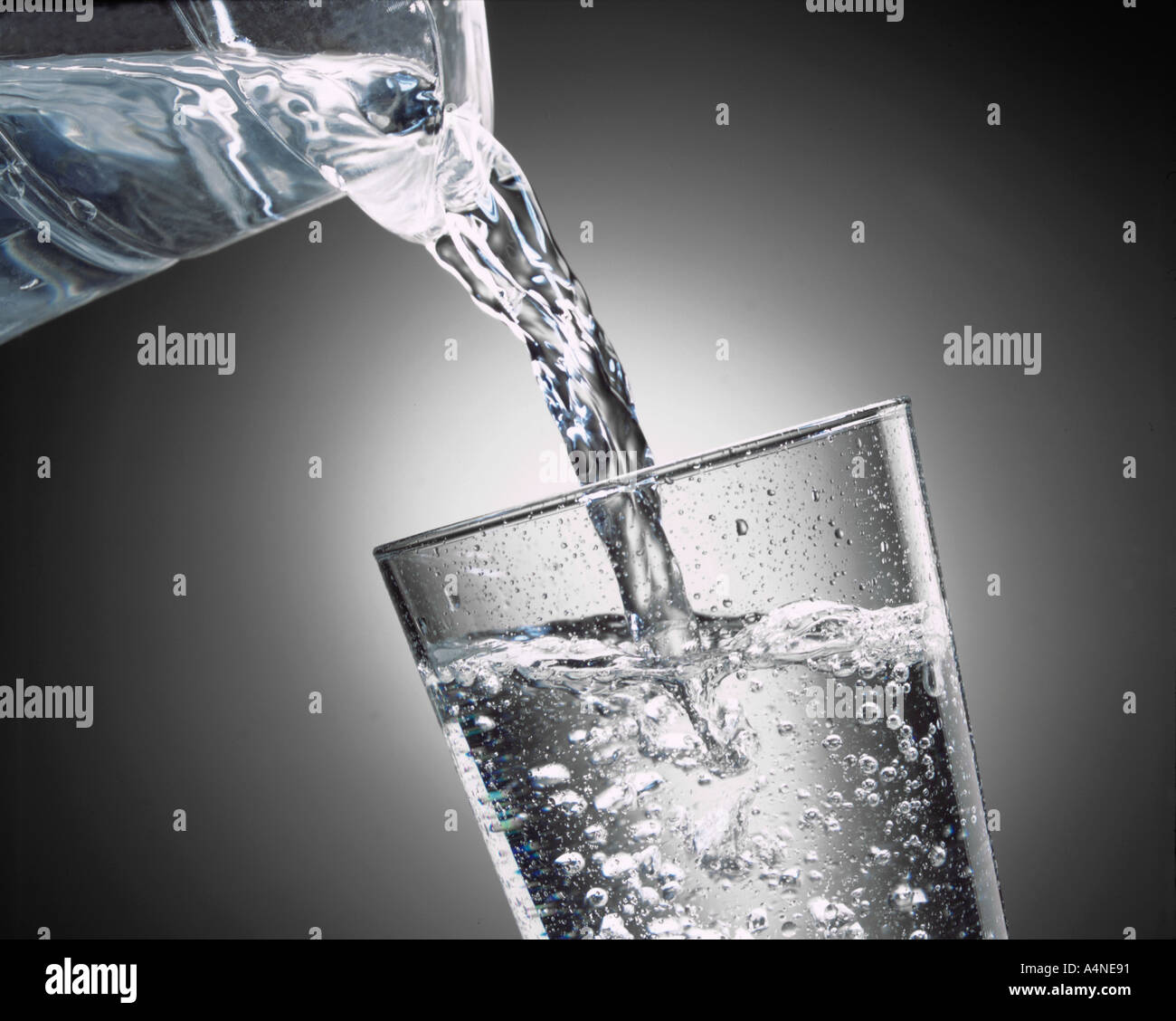pitcher of water pouring into clear glass Stock Photo - Alamy