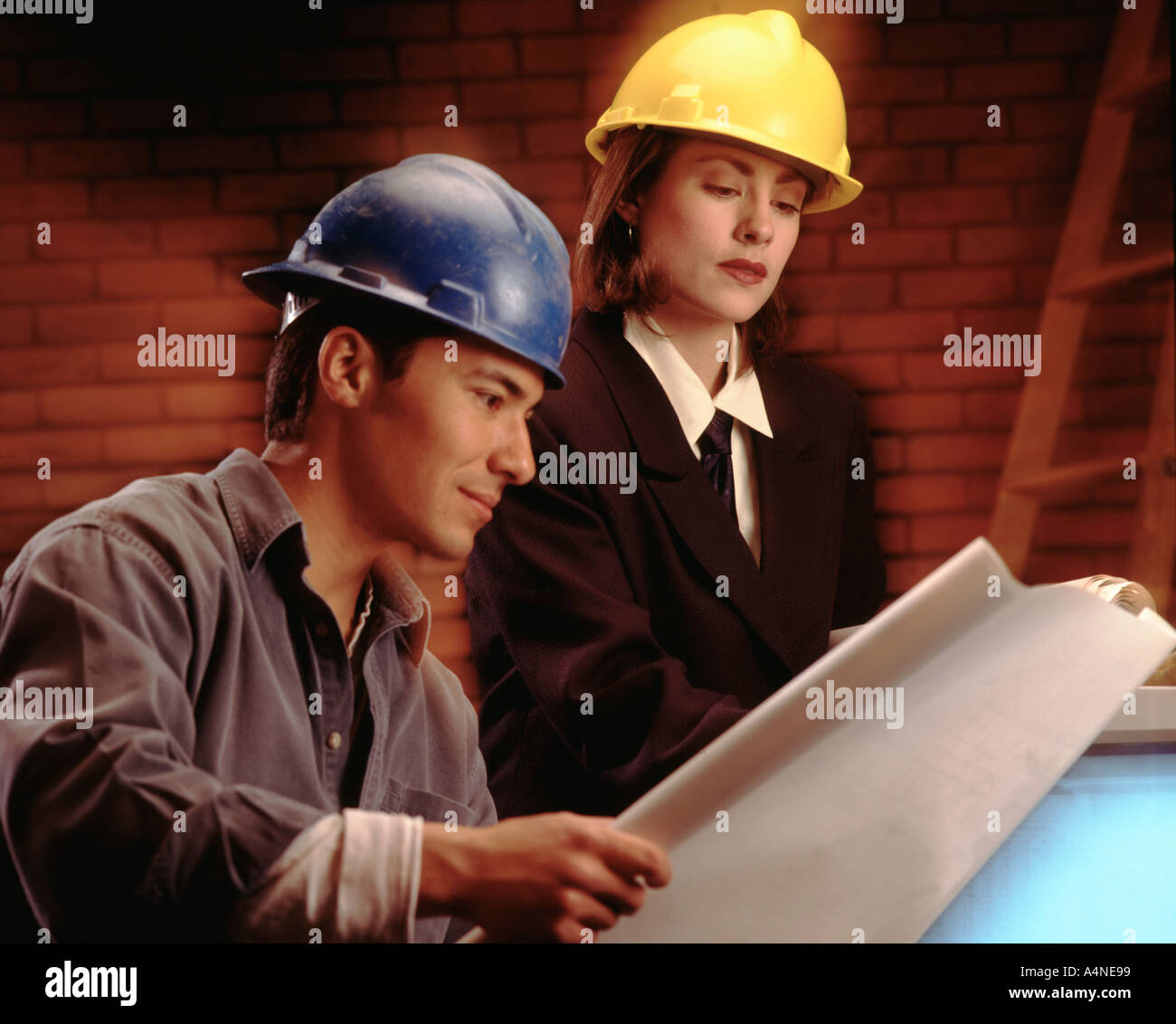construction worker and architect at work site with blueprints Stock ...