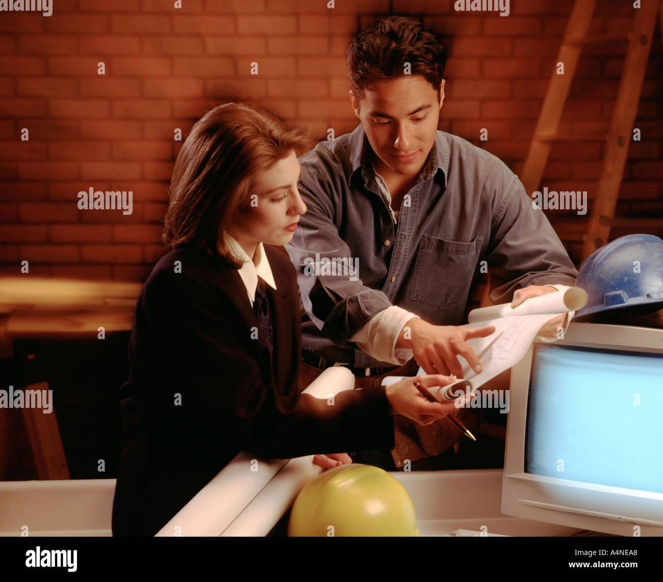 construction worker and architect at work site with blueprints Stock ...