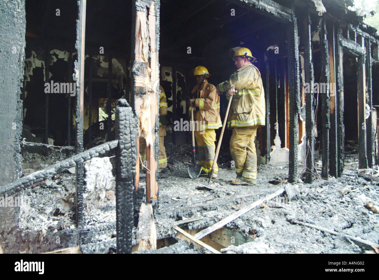 Fire fighters from several agencies investigate the cause of a ...