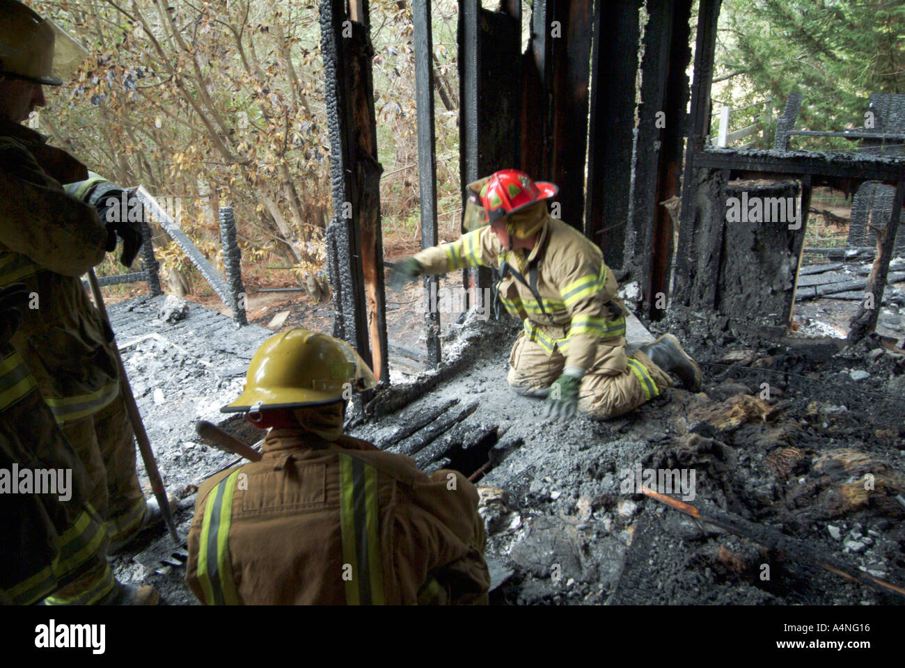 Fire fighters from several agencies investigate the cause of a ...