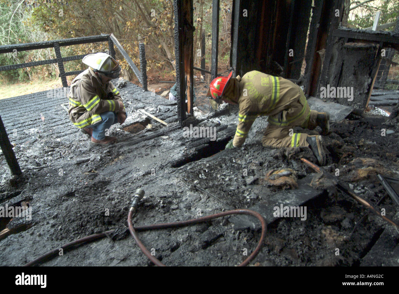 Fire fighters from several agencies investigate the cause of a ...