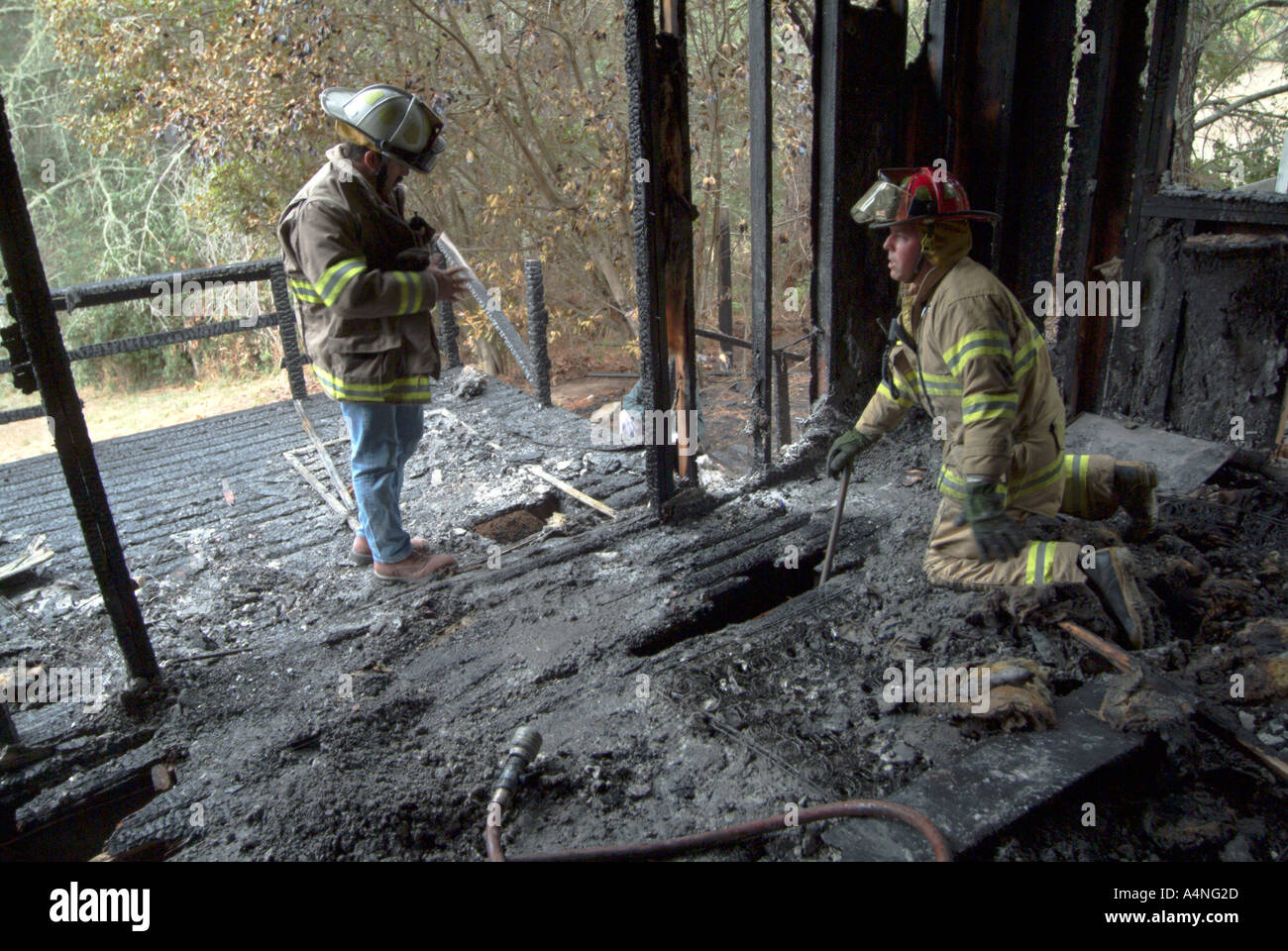 Fire fighters from several agencies investigate the cause of a ...
