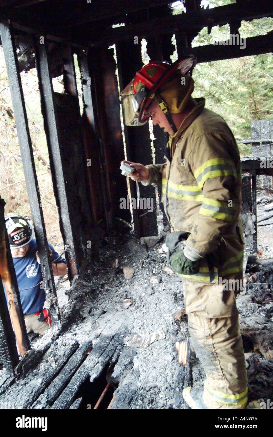 Fire fighters from several agencies investigate the cause of a ...