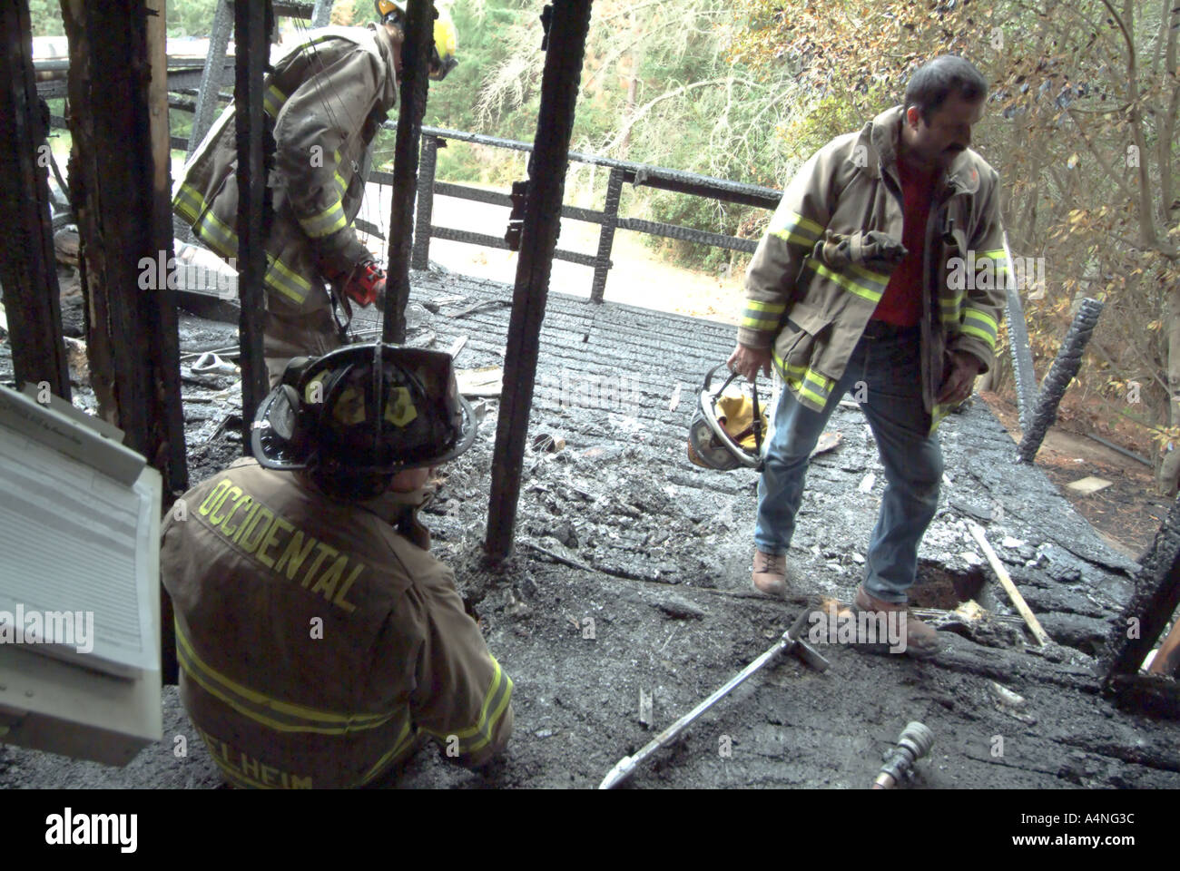 Fire fighters from several agencies investigate the cause of a ...