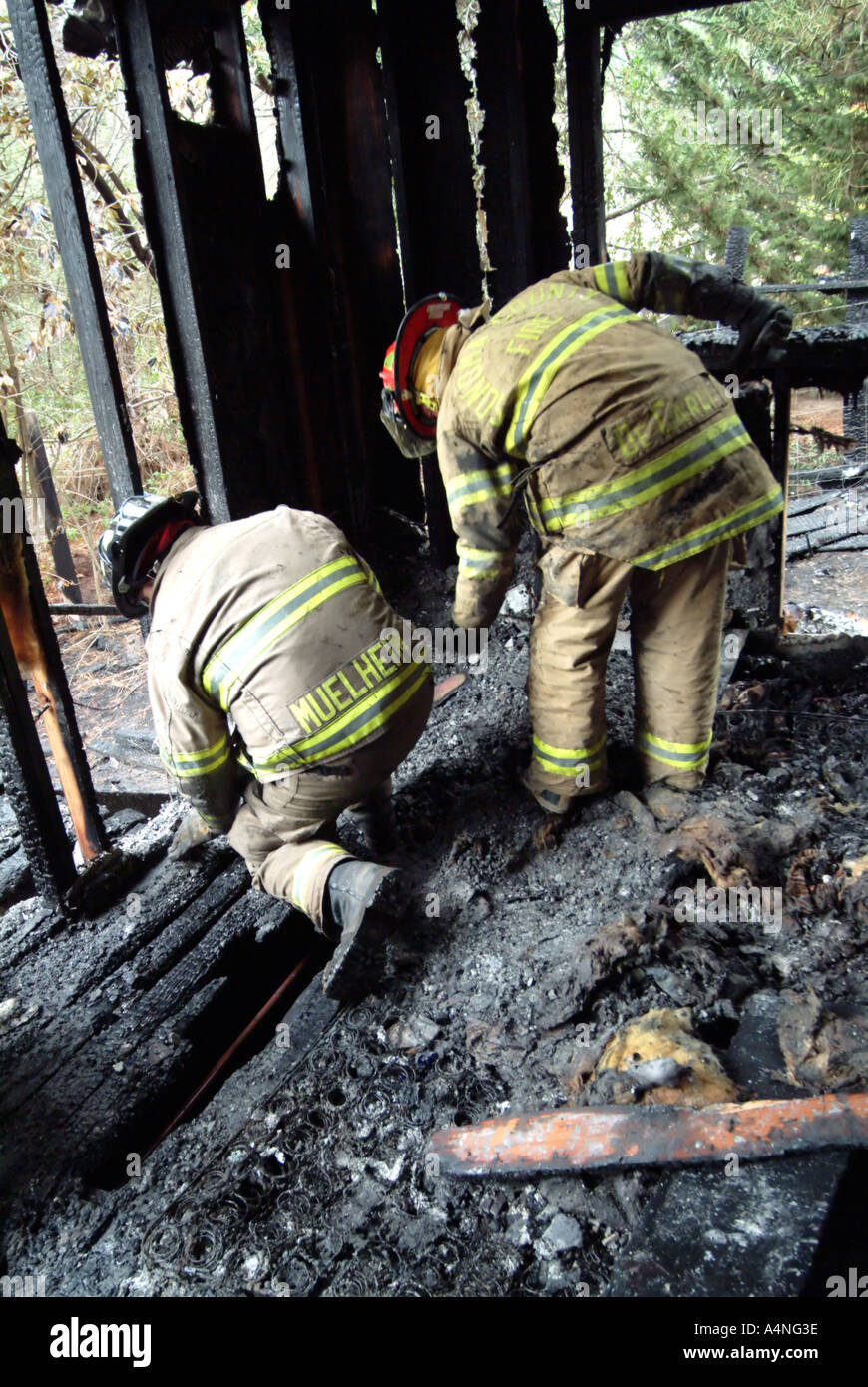Fire fighters from several agencies investigate the cause of a ...