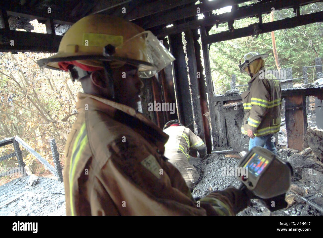 Fire fighters from several agencies investigate the cause of a ...