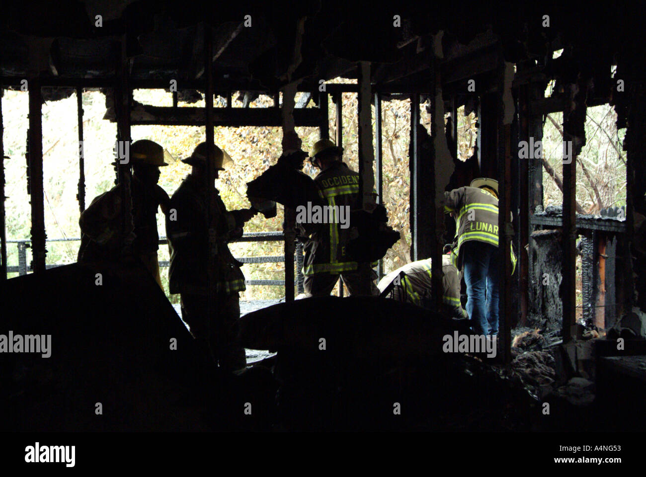 Fire fighters from several agencies investigate the cause of a ...