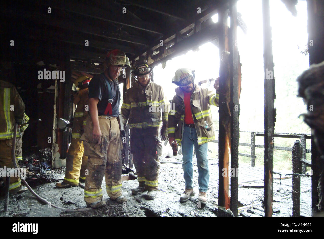 Fire fighters from several agencies investigate the cause of a ...