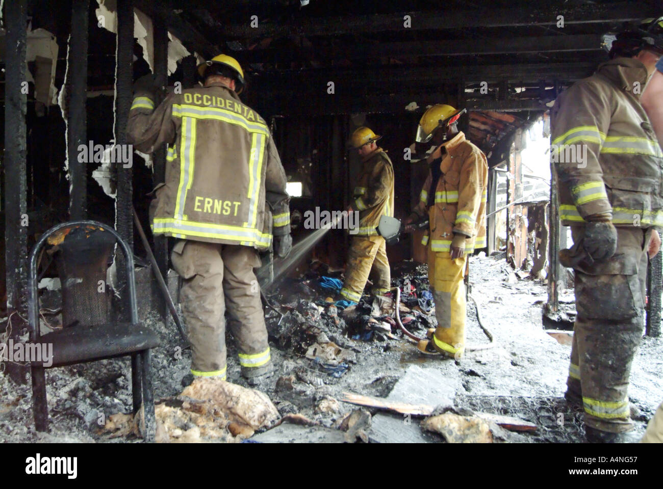Fire fighters from several agencies investigate the cause of a ...